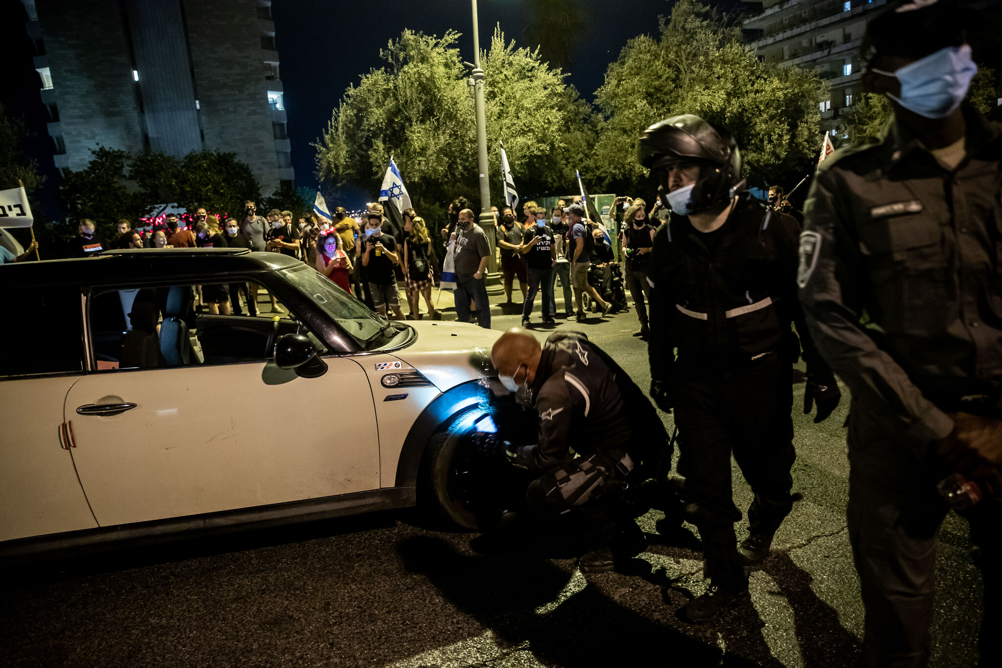 Driver held for speeding toward protesters as thousands rally against ...