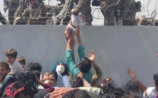 Reunited: Viral clip of Marine lifting baby at airport wall captures ...