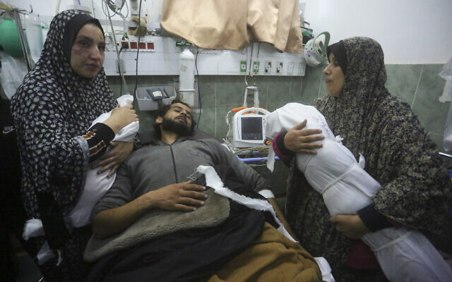 Gazan father bids farewell to dead children from his hospital bed | The ...