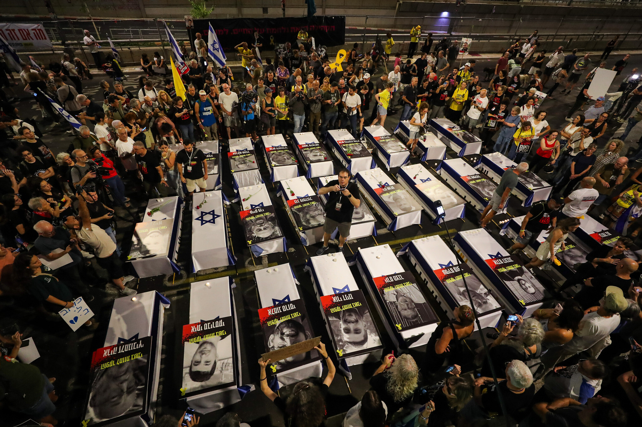 'Government of blood': Protesters stage mock funeral for slain hostages ...