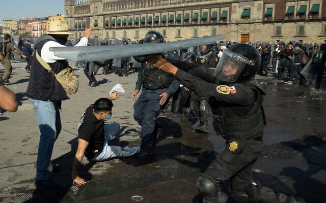 Clashes injure 120, mostly police officers, at protest against Mexican ...